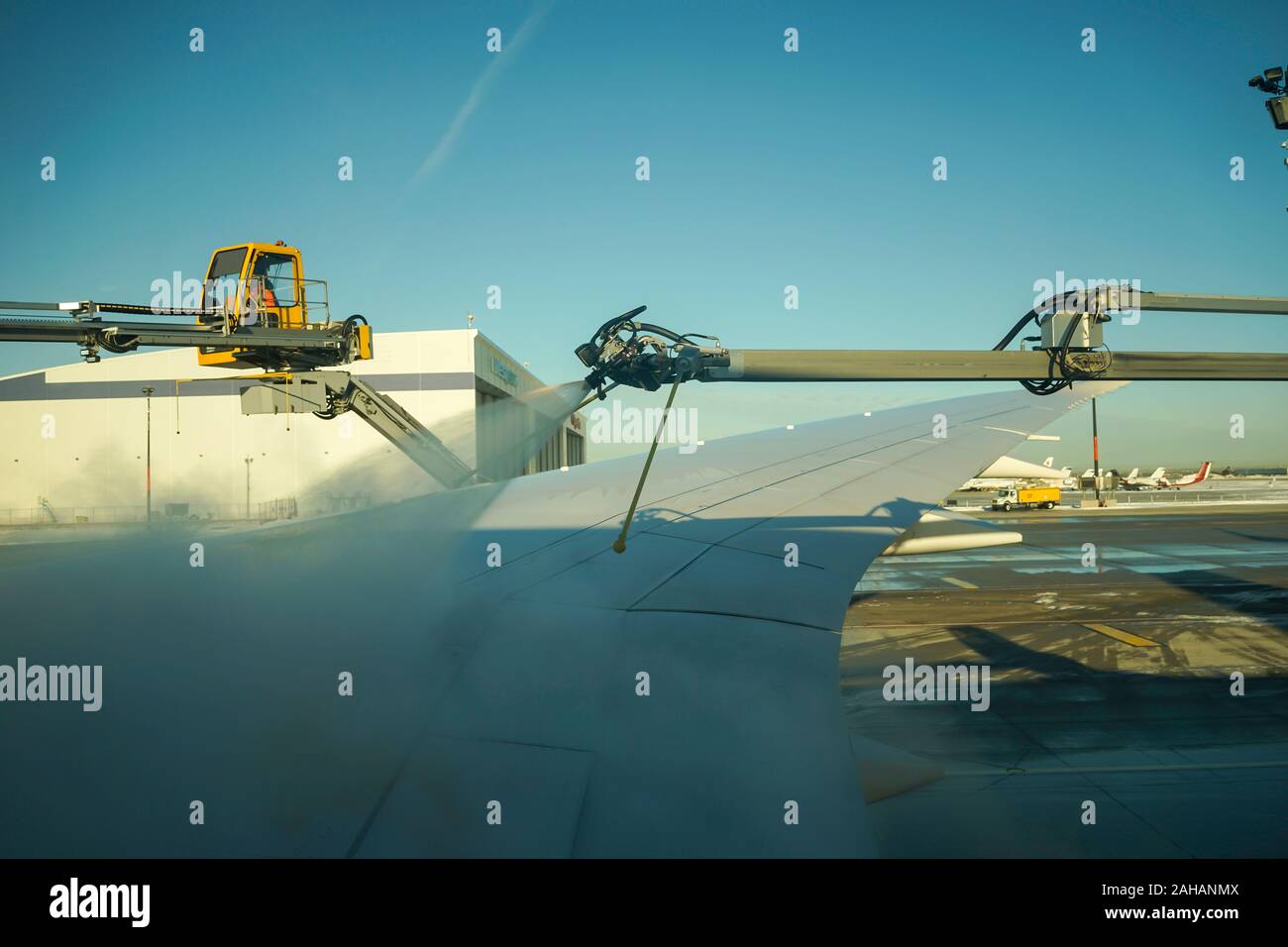 Boeing 737 wing worker is de-icing a commercial airliner wing in ...