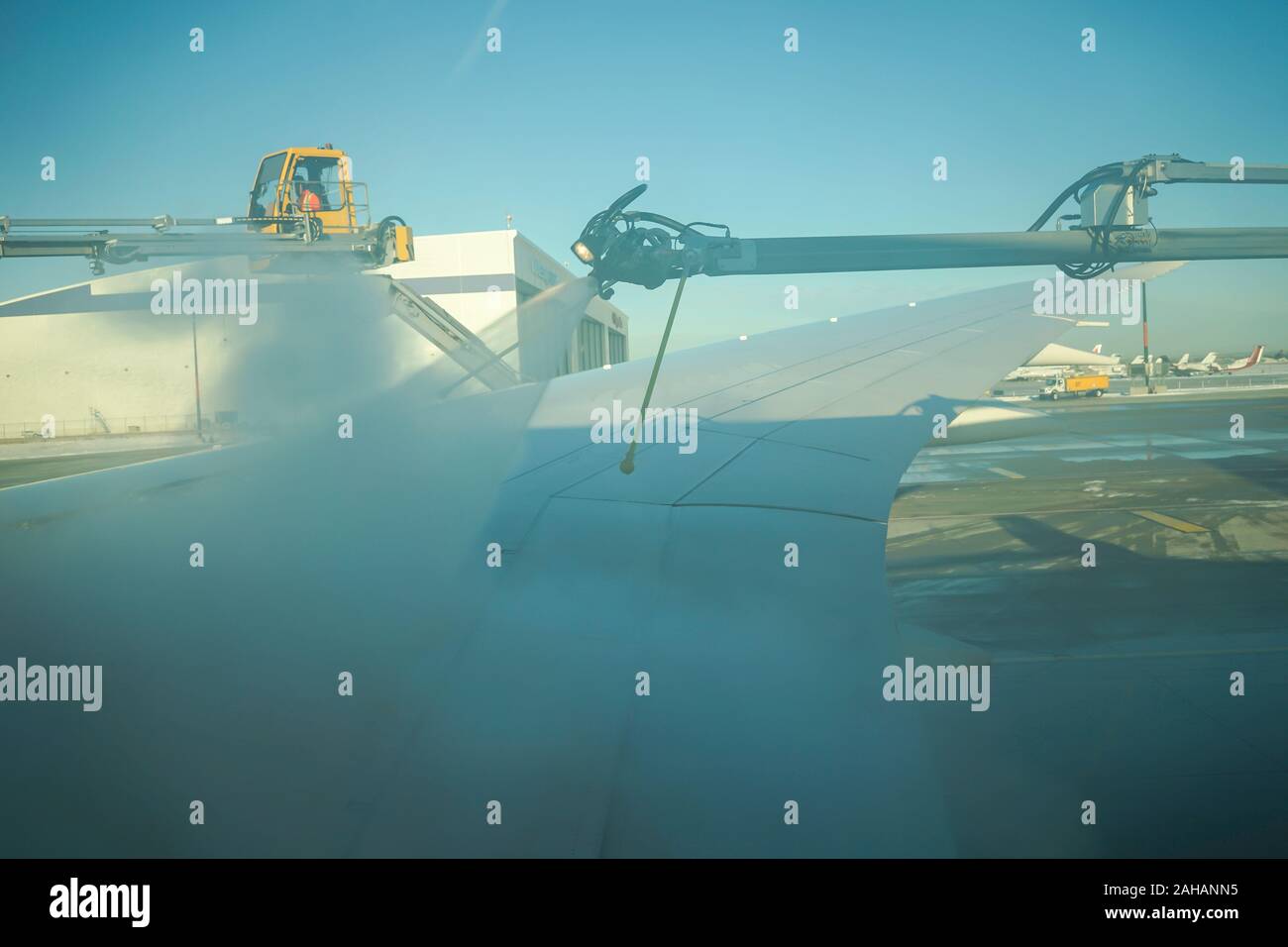 Boeing 737 wing worker is de-icing a commercial airliner wing in ...