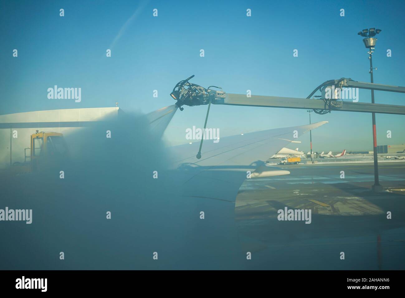 Boeing 737 wing worker is de-icing a commercial airliner wing in ...
