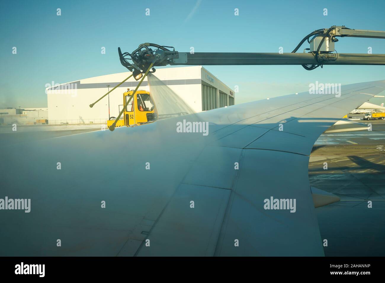 Boeing 737 wing worker is de-icing a commercial airliner wing in ...