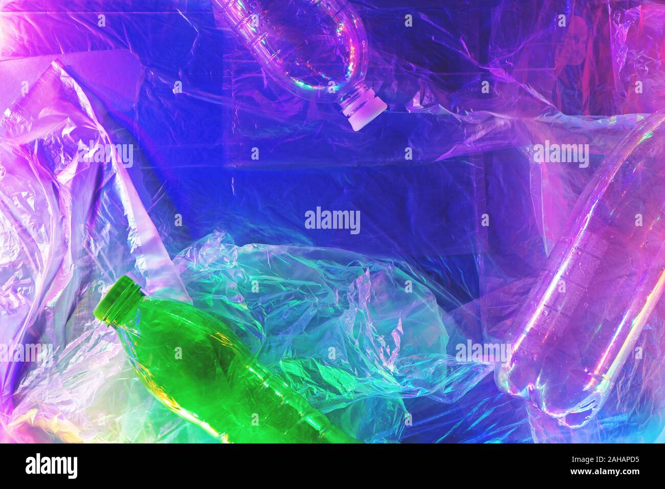 Plastic bottles on plastic background in neon lights. Zero waste ...
