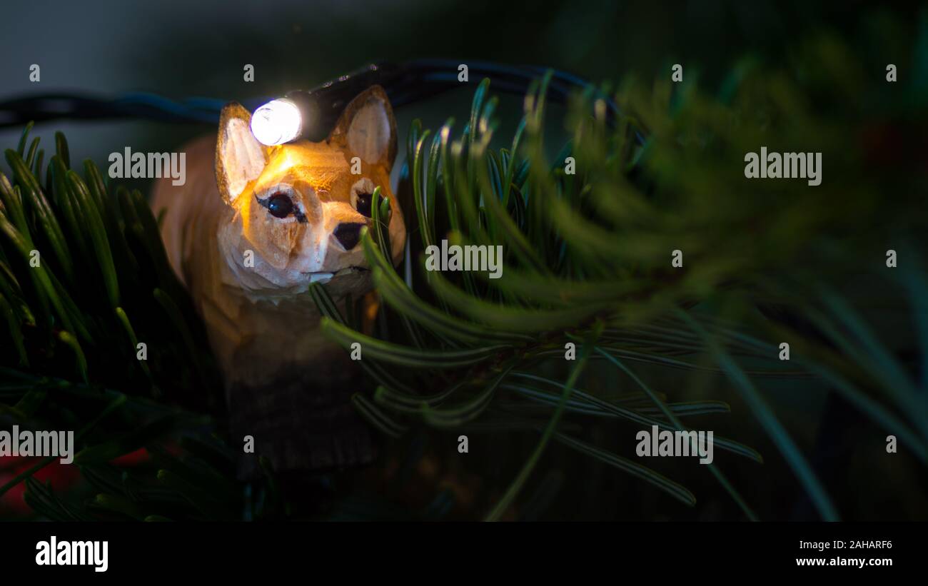 A small wooden fox used as a Christmas tree decoration Stock Photo - Alamy