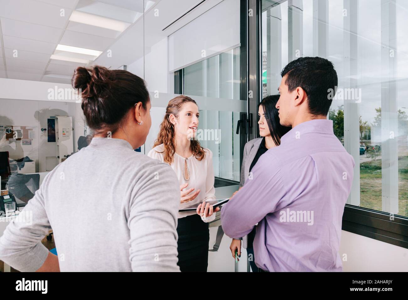 Group of office workers at a meeting around the boss Stock Photo - Alamy