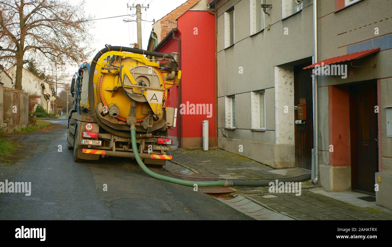 Septic cesspool pumping into tank truck by suction hose under high ...