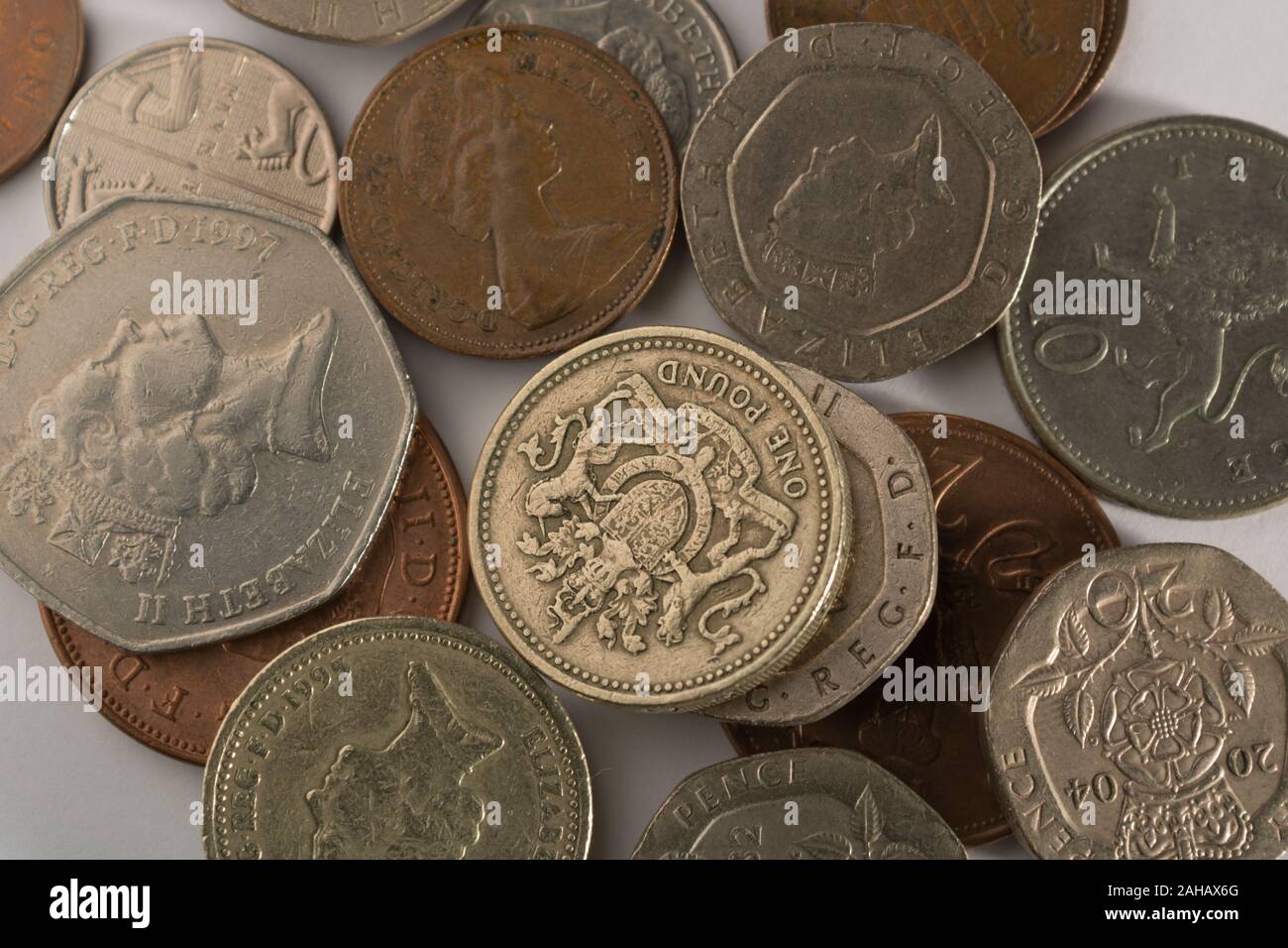 Different coins of different value on white background Stock Photo - Alamy