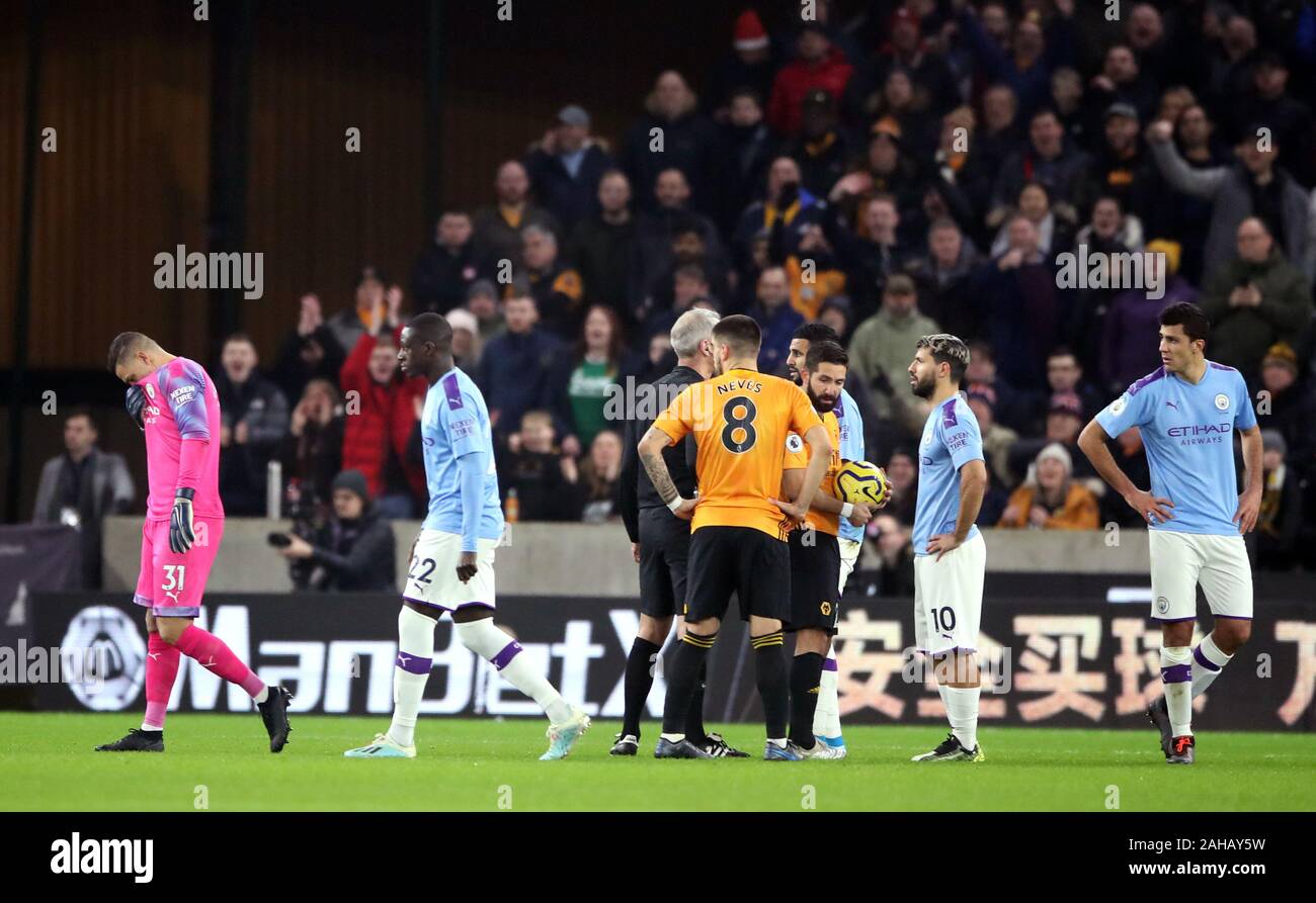 Manchester City goalkeeper Ederson (left) walks off after being a shown ...