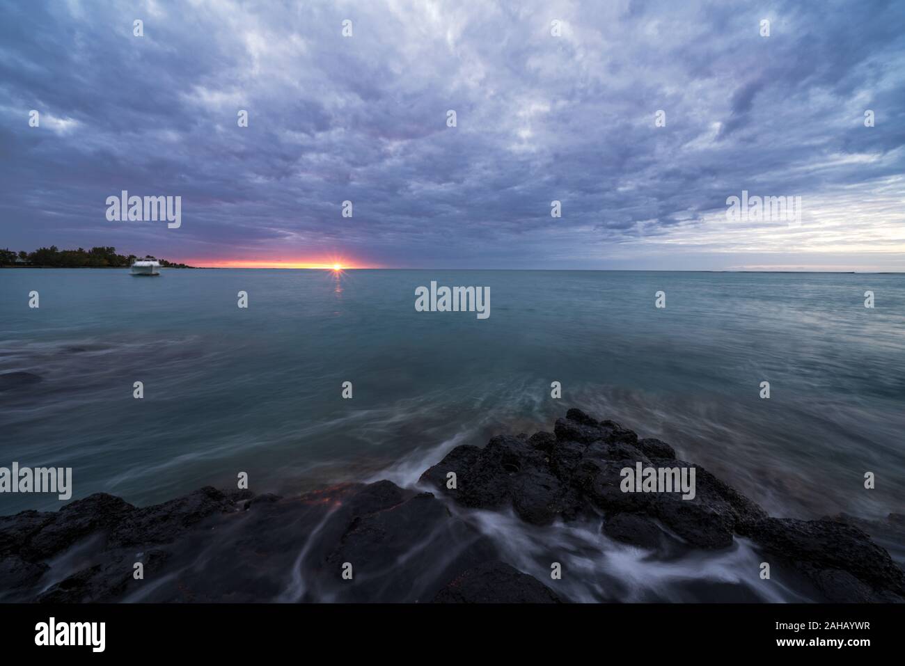 Dramatic cloudy sky at sunset over the ocean waves, Grand Baie ...