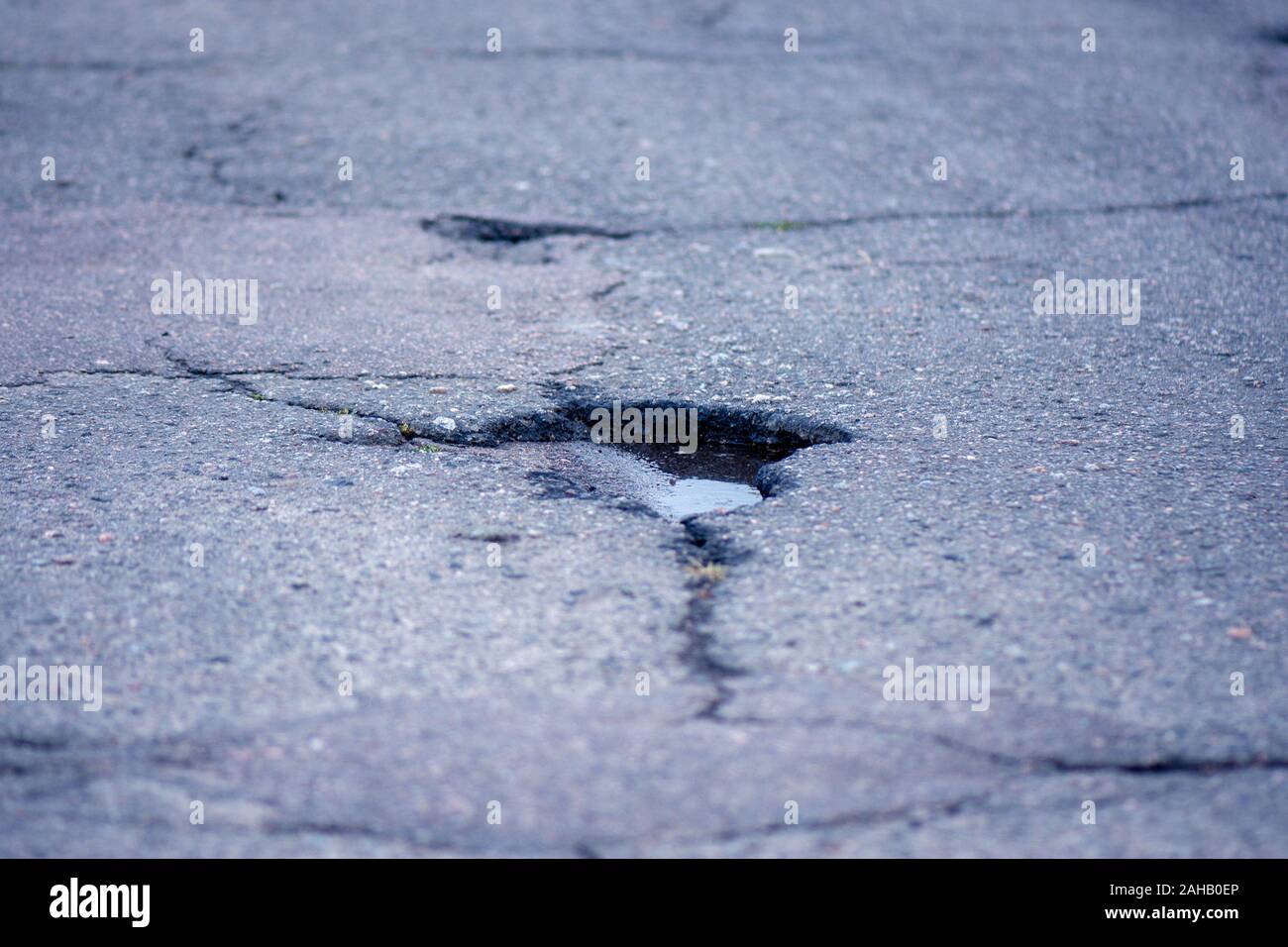 background texture of a crack on a road surface close-up in the sun ...