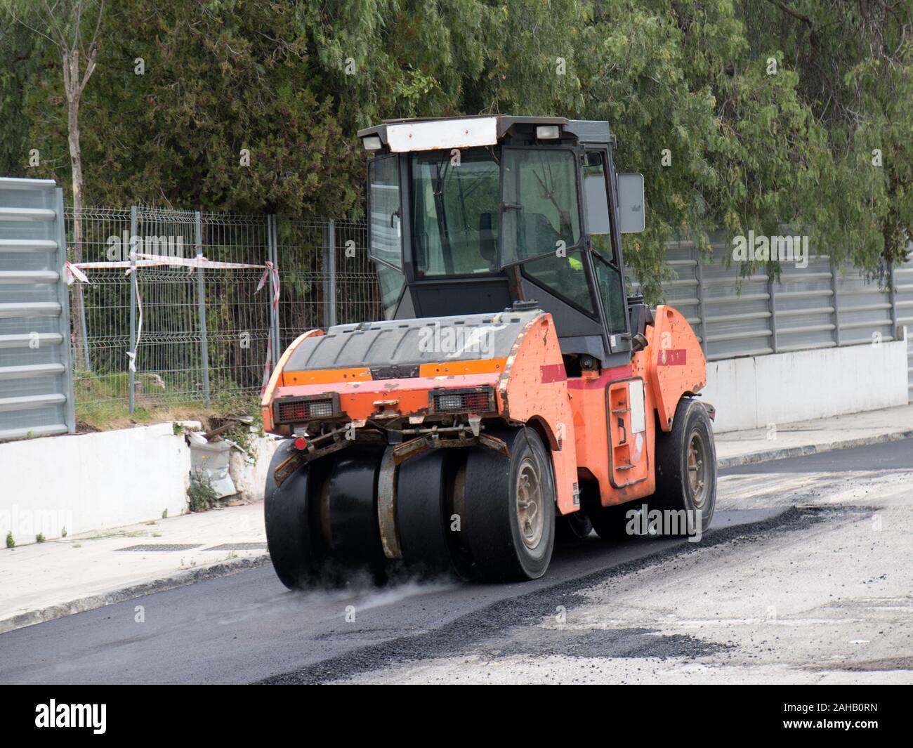 Roller machine paving a city street Stock Photo - Alamy