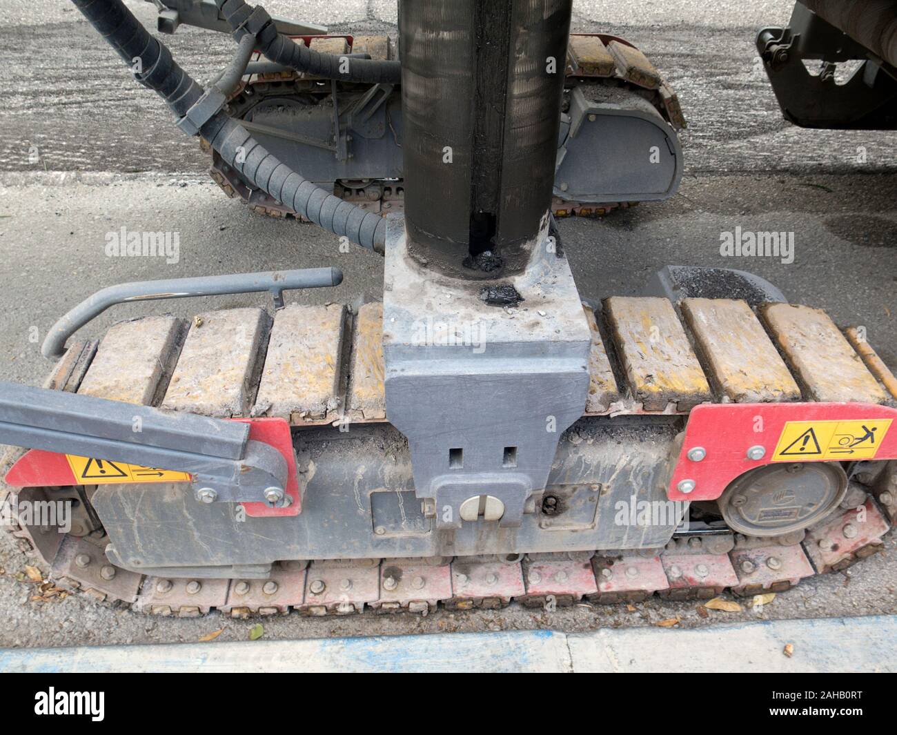 Hydraulic chain of asphalt tamping machine Stock Photo - Alamy