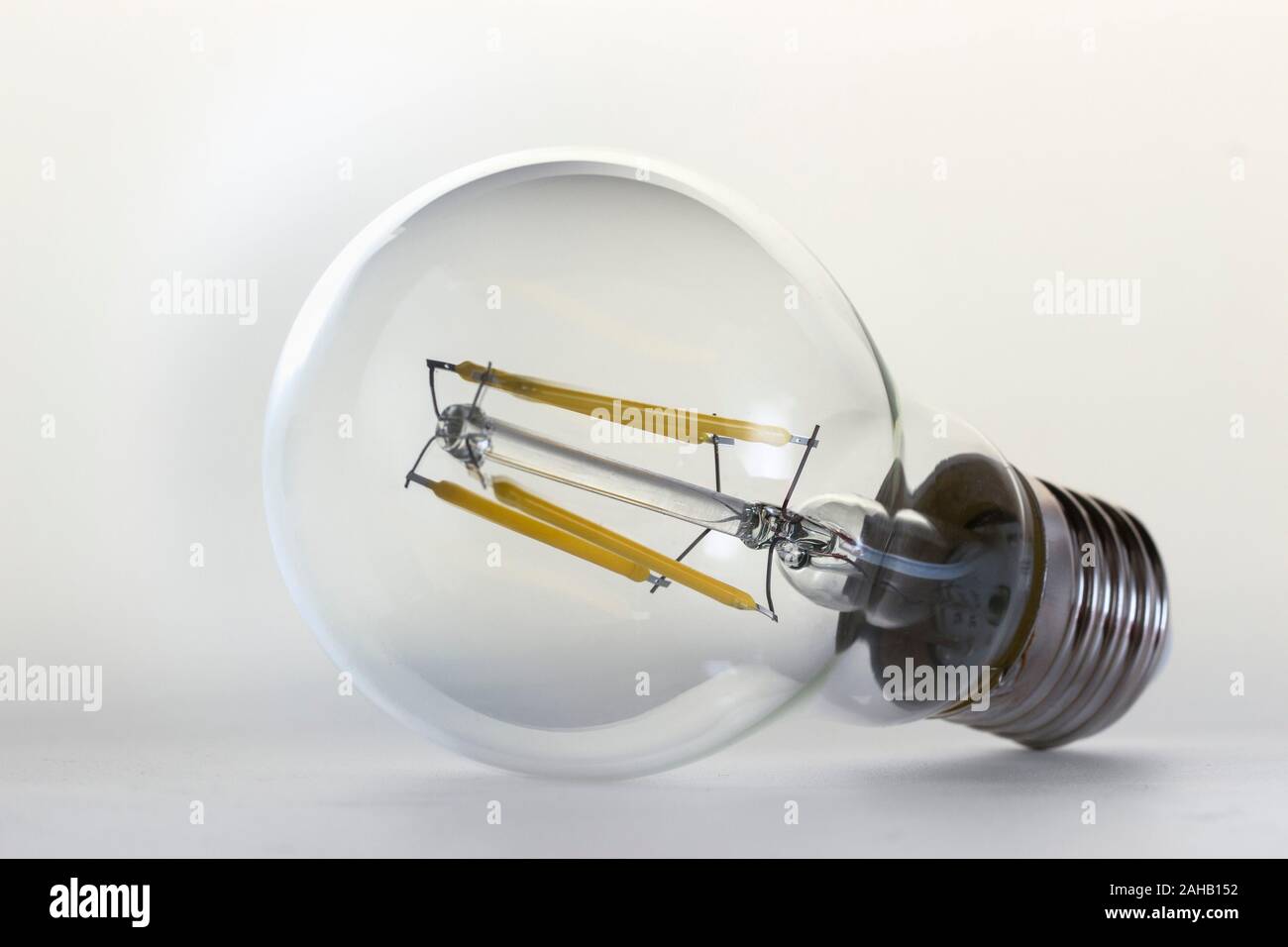 LED light bulb with spiral shaped elements on a white background Stock ...