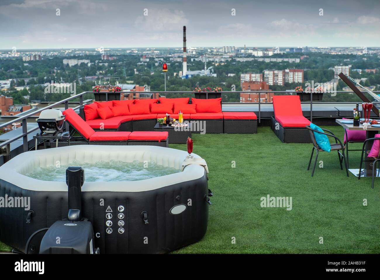 Outdoor jacuzzi in relax zone on the rooftop terrace in modern living ...