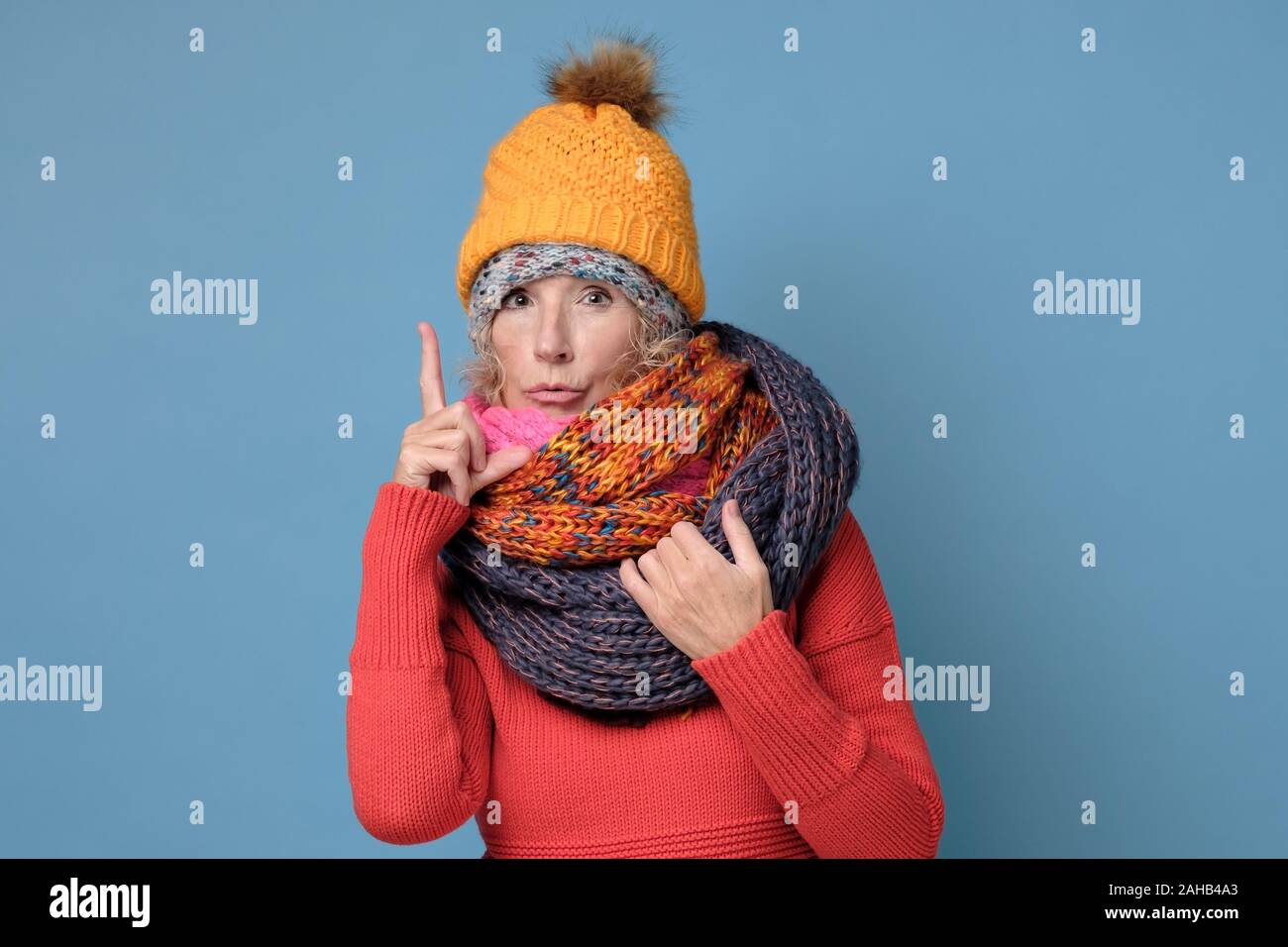 Funny senior caucasian woman wearing winter clothes being cold and ...