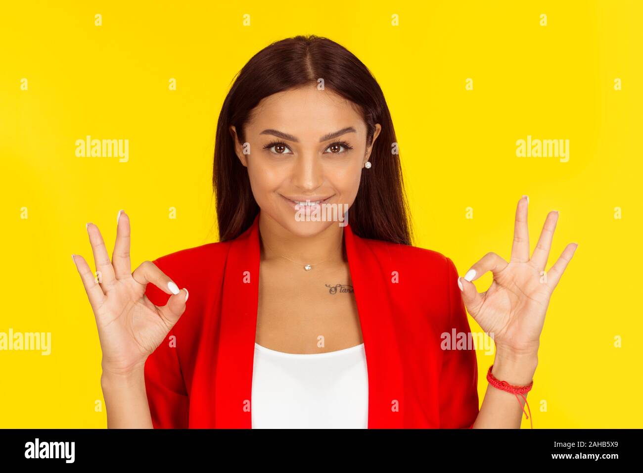 Everything is alright. Multicultural model showing ok sign with both ...