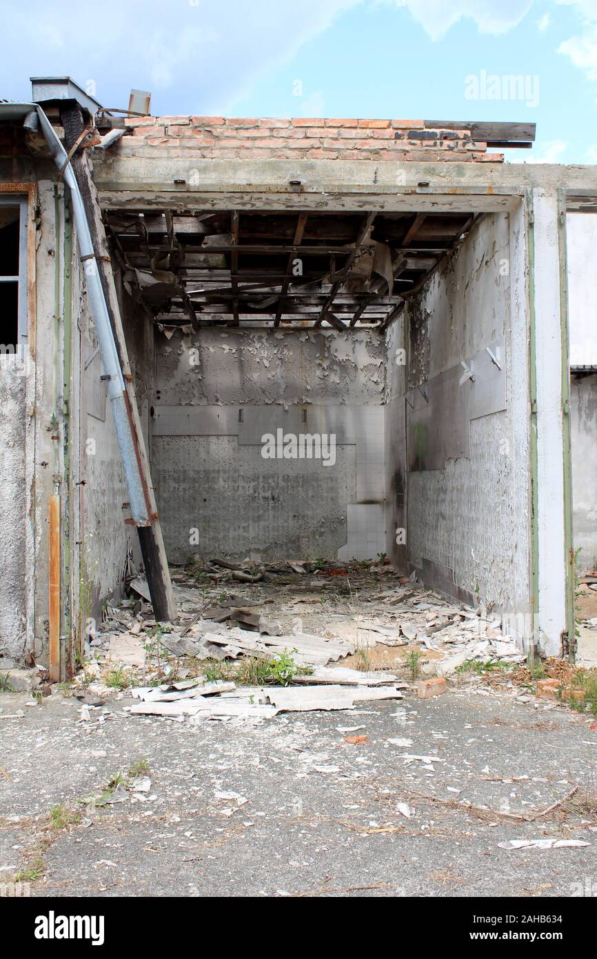 Demolished destroyed garage at abandoned industrial complex with ...