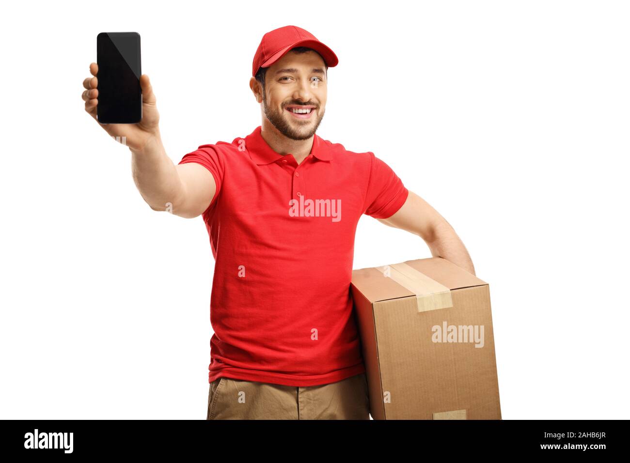 Smiling guy holding a package and showing a mobile phone isolated on ...