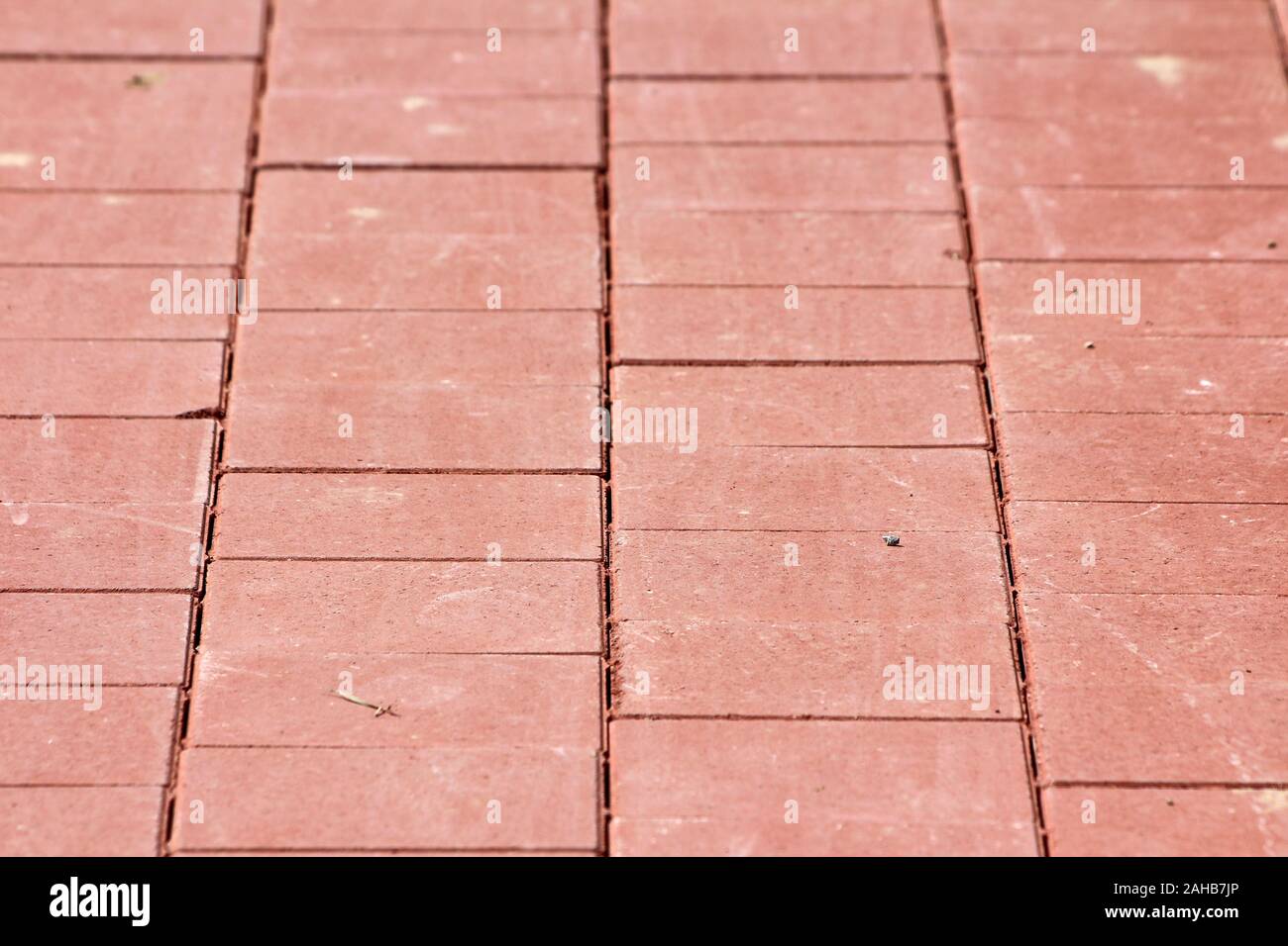 Light red rectangle stone tiles texture at local public park sidewalk ...