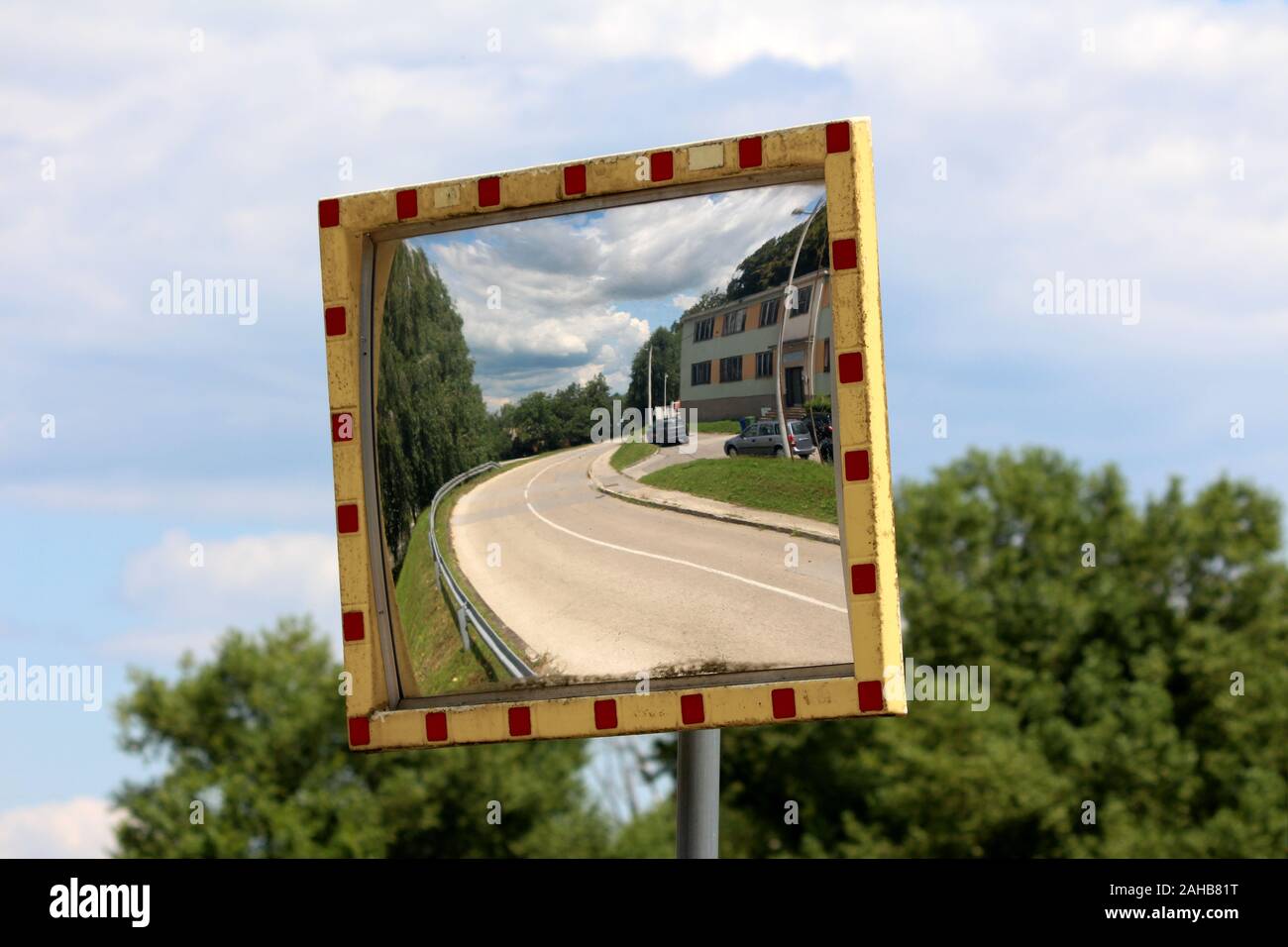 Old convex rectangular traffic mirror with dilapidated red and white ...