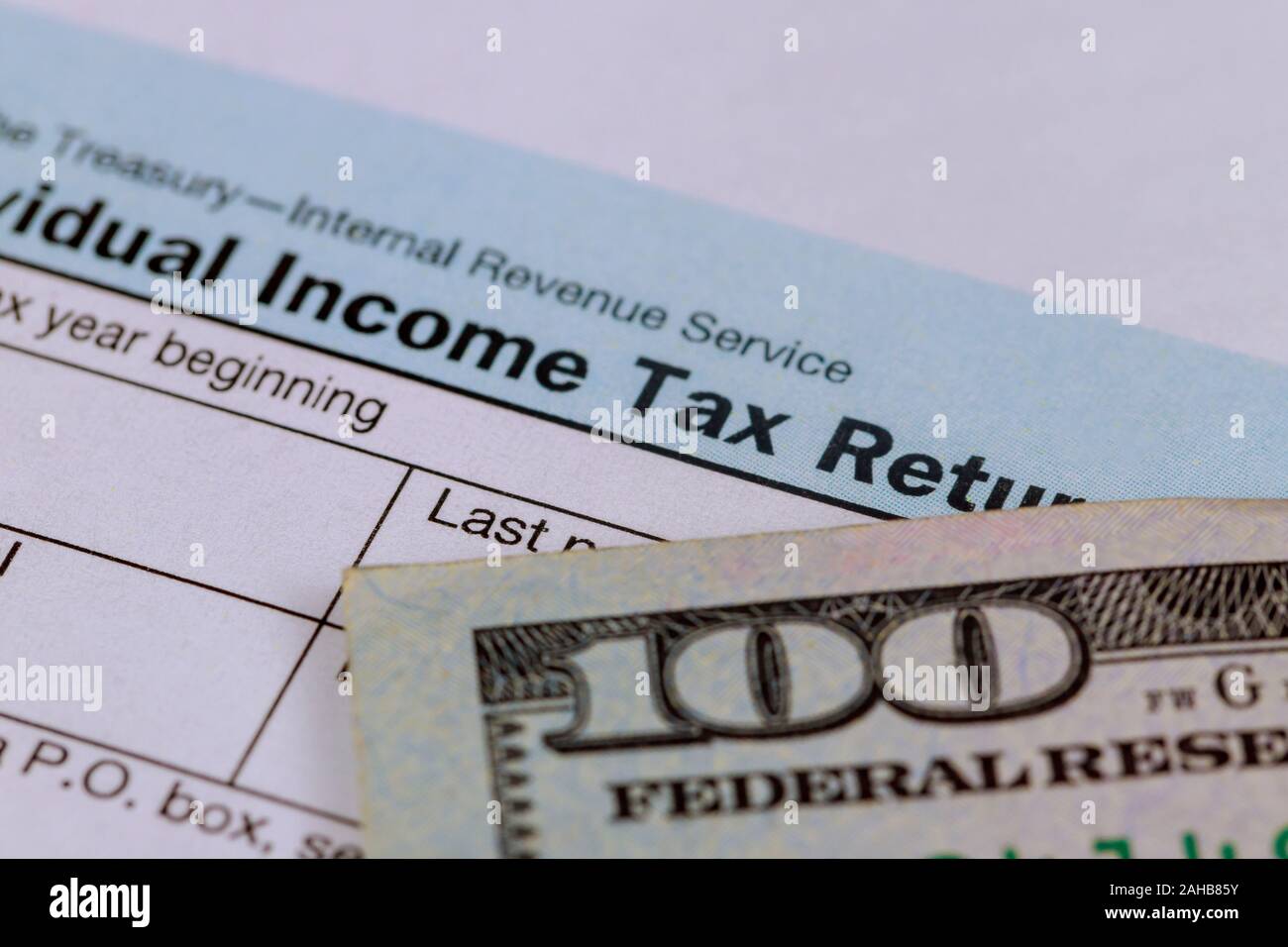 Economic stimulus tax 1040 form and US 100 dollar bills currency Stock ...