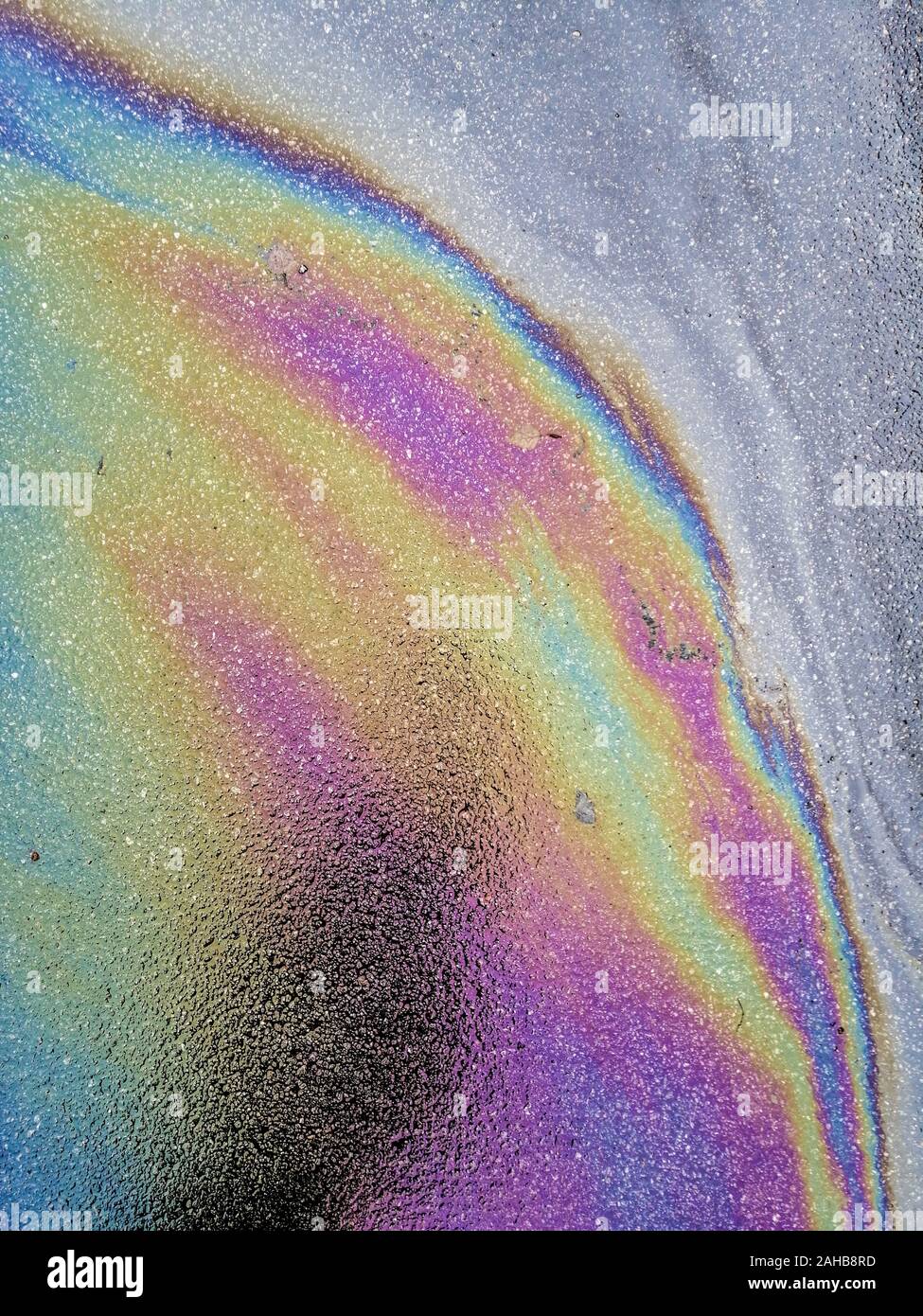 Multi colored oil spill on asphalt road, abstract background Stock ...
