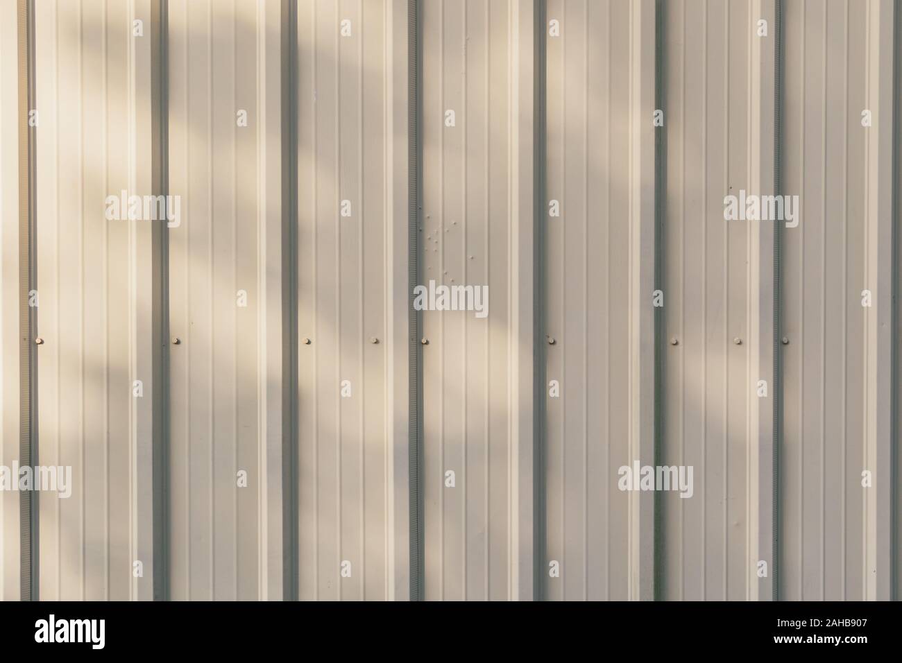 Cream metal siding wall with shadows background texture Stock Photo - Alamy