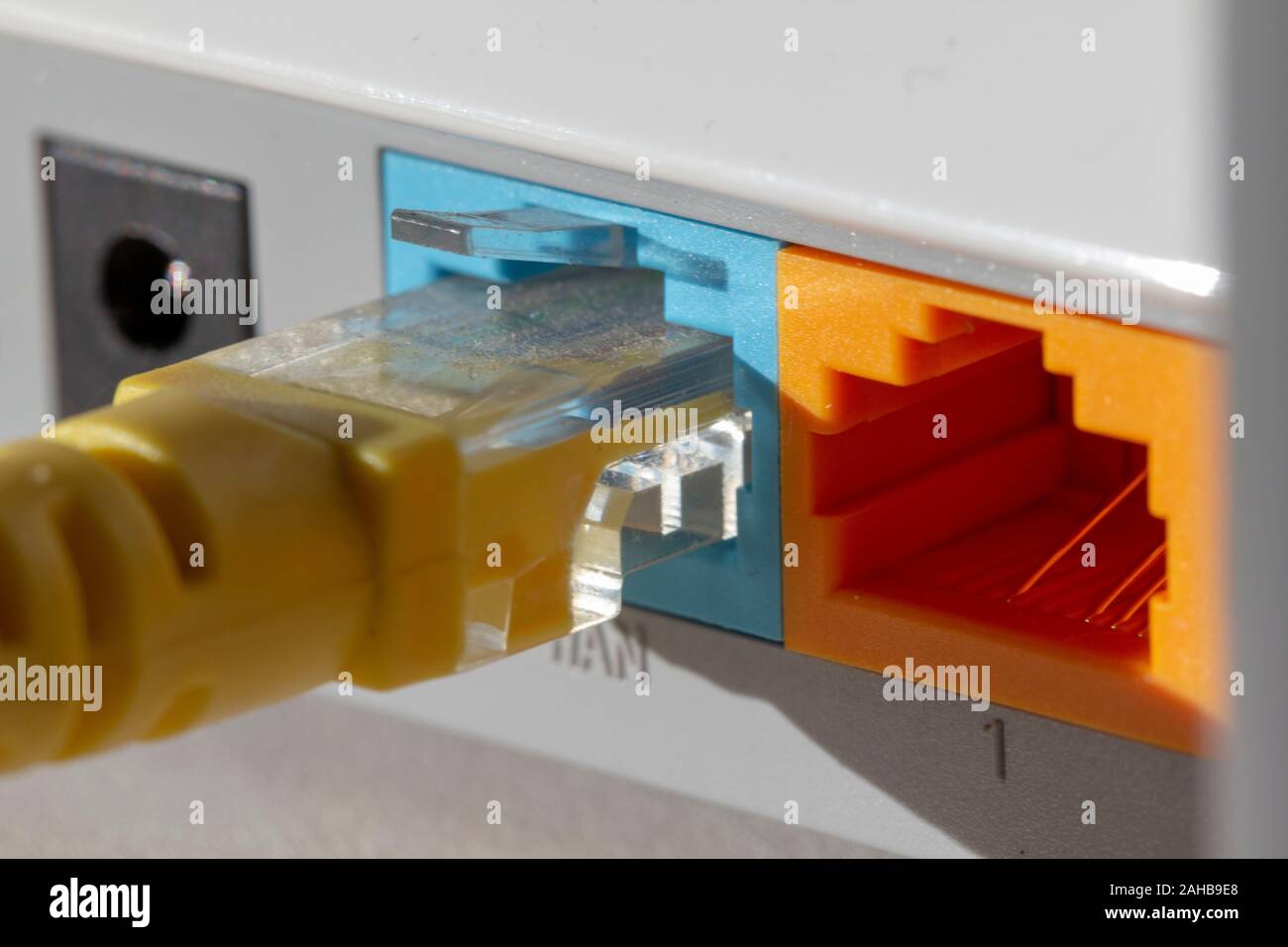 yellow internet cable in blue on the back of the network router Stock ...