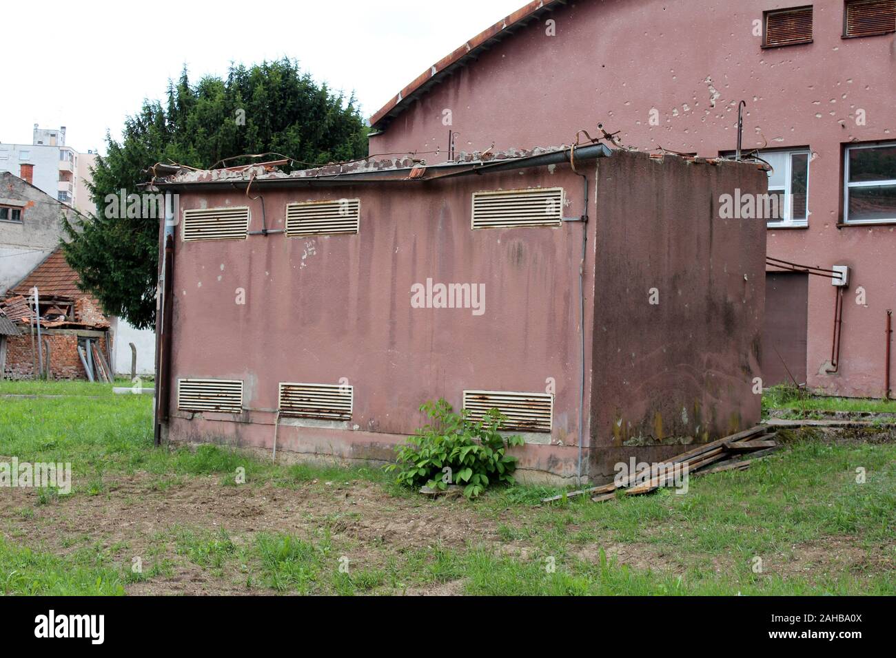 Small storage building with six white rusted metal ventilation openings ...