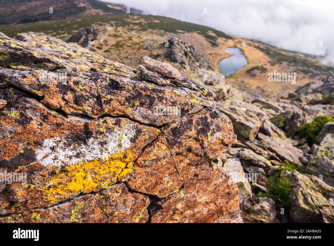 Marks on a rock of a small path to guide hikers, in the Sierra de ...