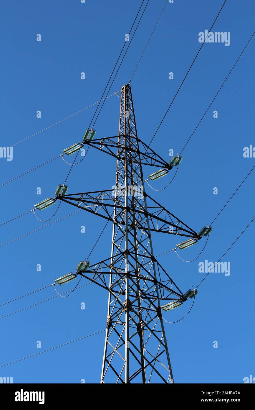 Tall large power line utility pole made of metal pipes with seven ...