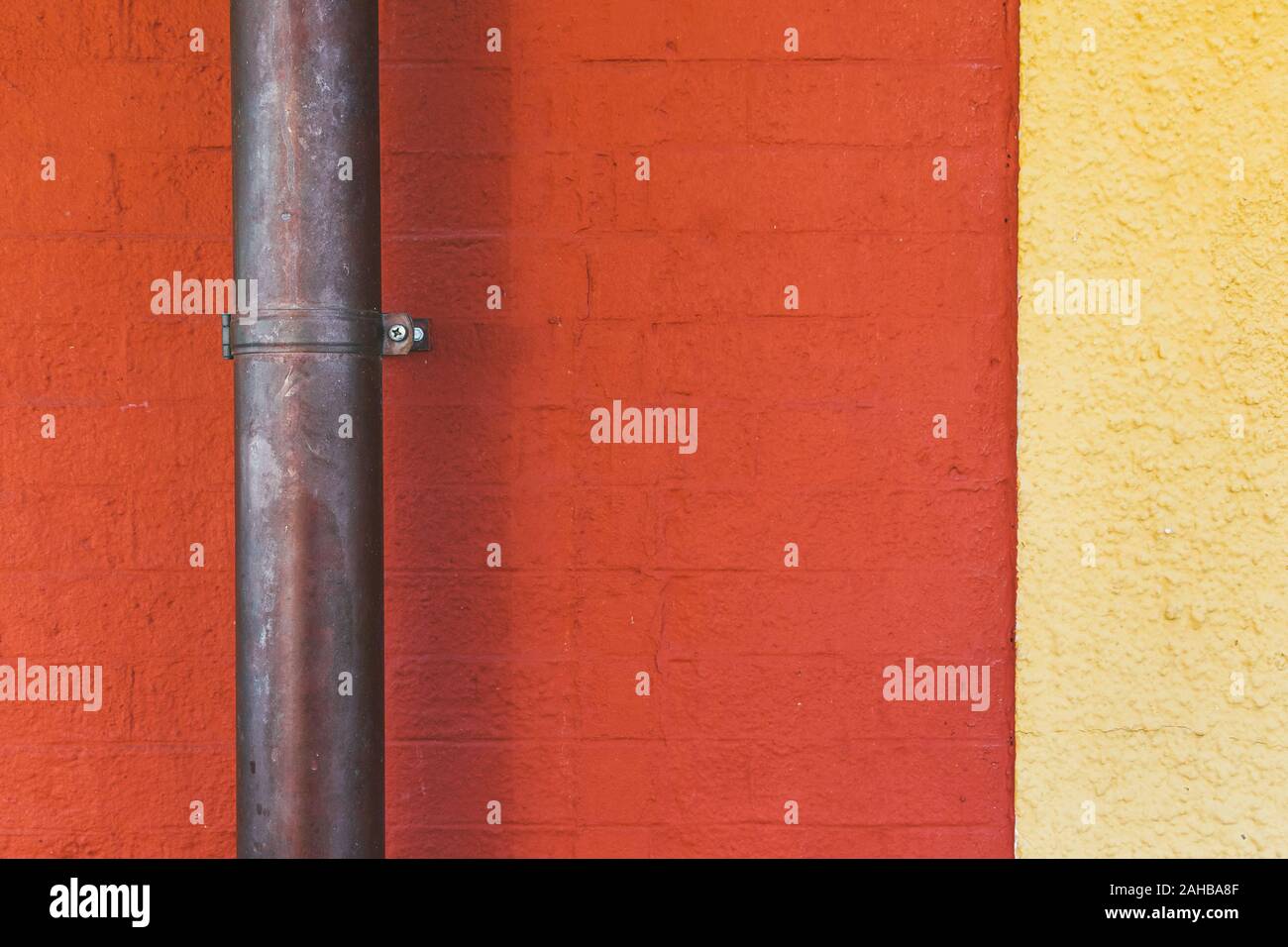 Vintage pipe on a red yellow concrete wall background texture Stock ...