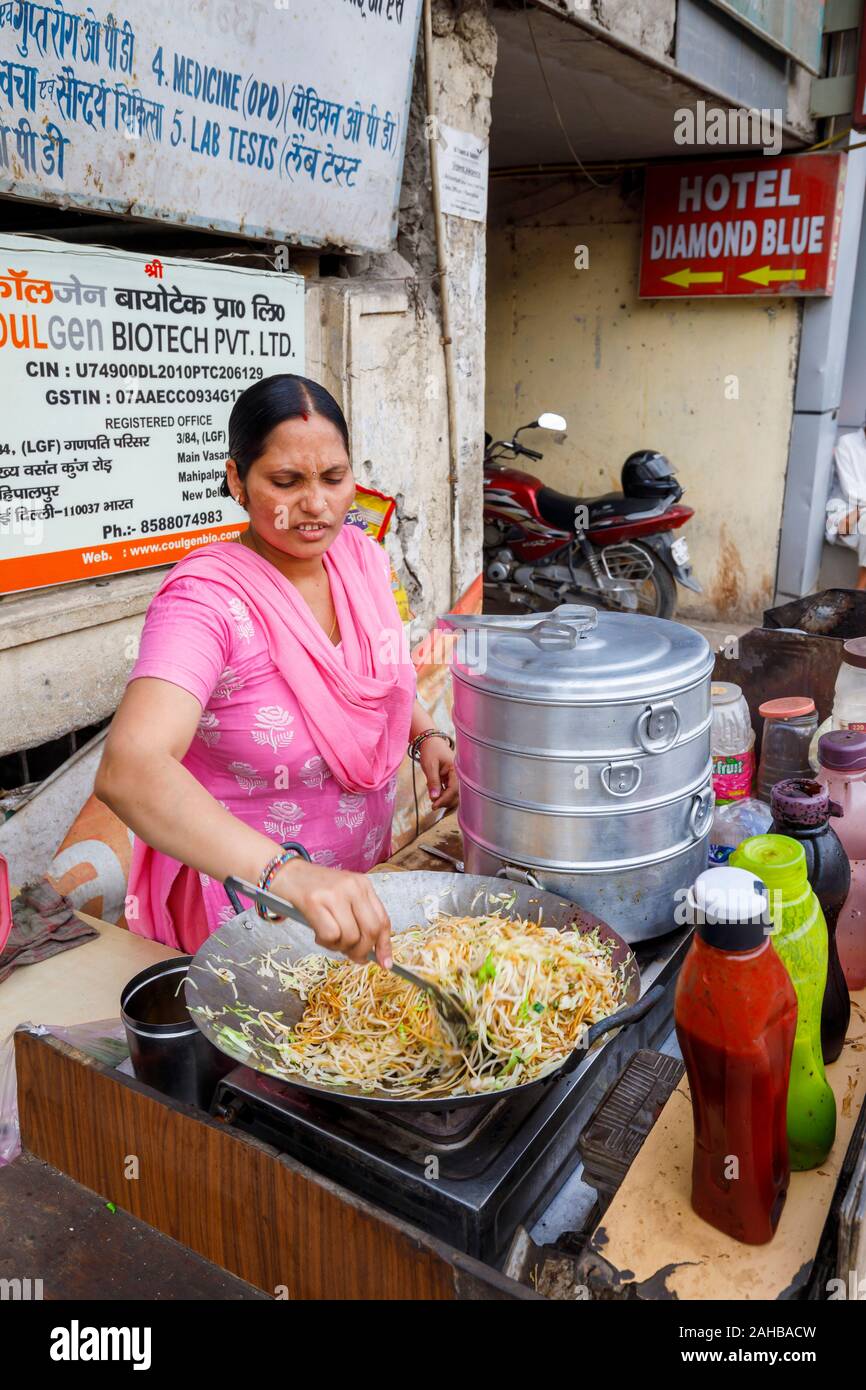 Local woman cooking bean sprouts for street food: street scene in ...