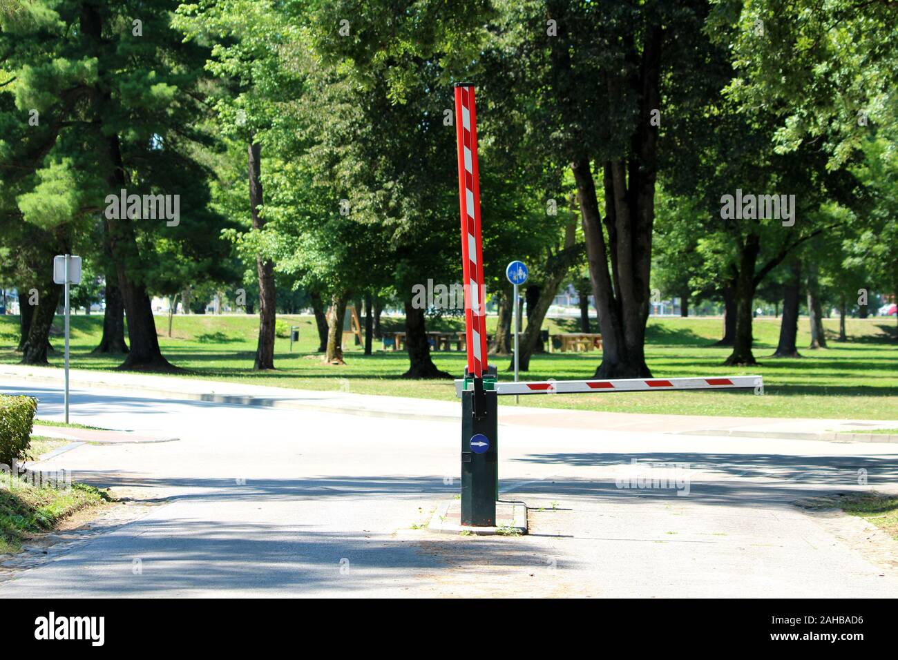 Two closed and open automatic red and white striped metal ramps with ID ...