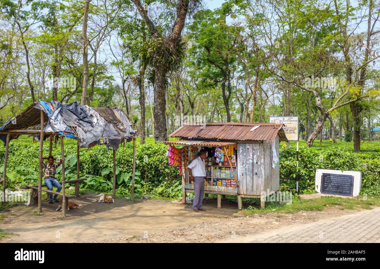 Typical small dilapidated roadside hut stall with a customer selling ...