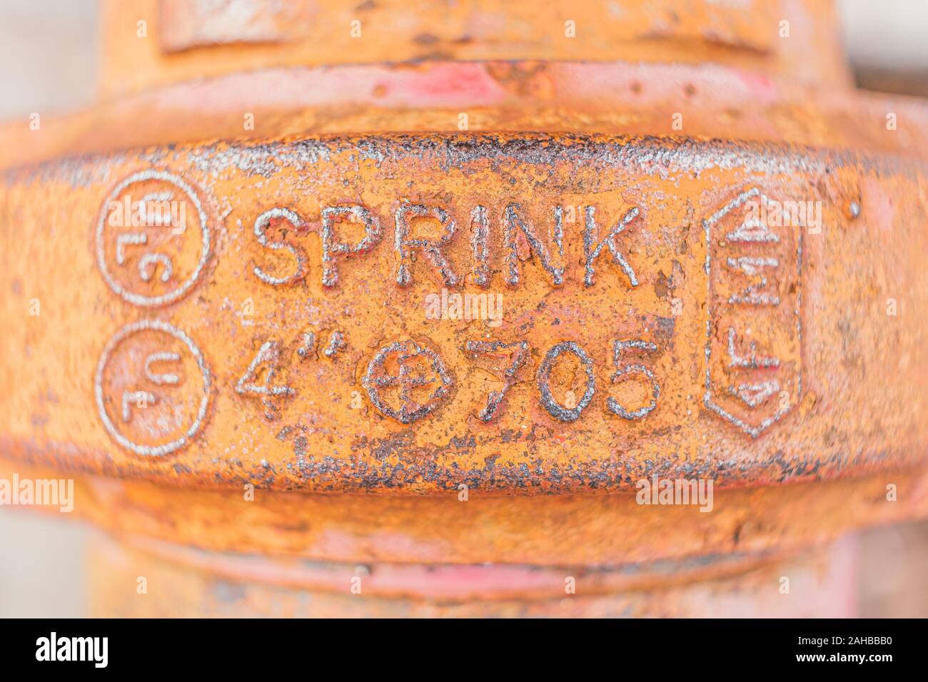 Rusty old orange sprinkler pipe background texture Stock Photo - Alamy