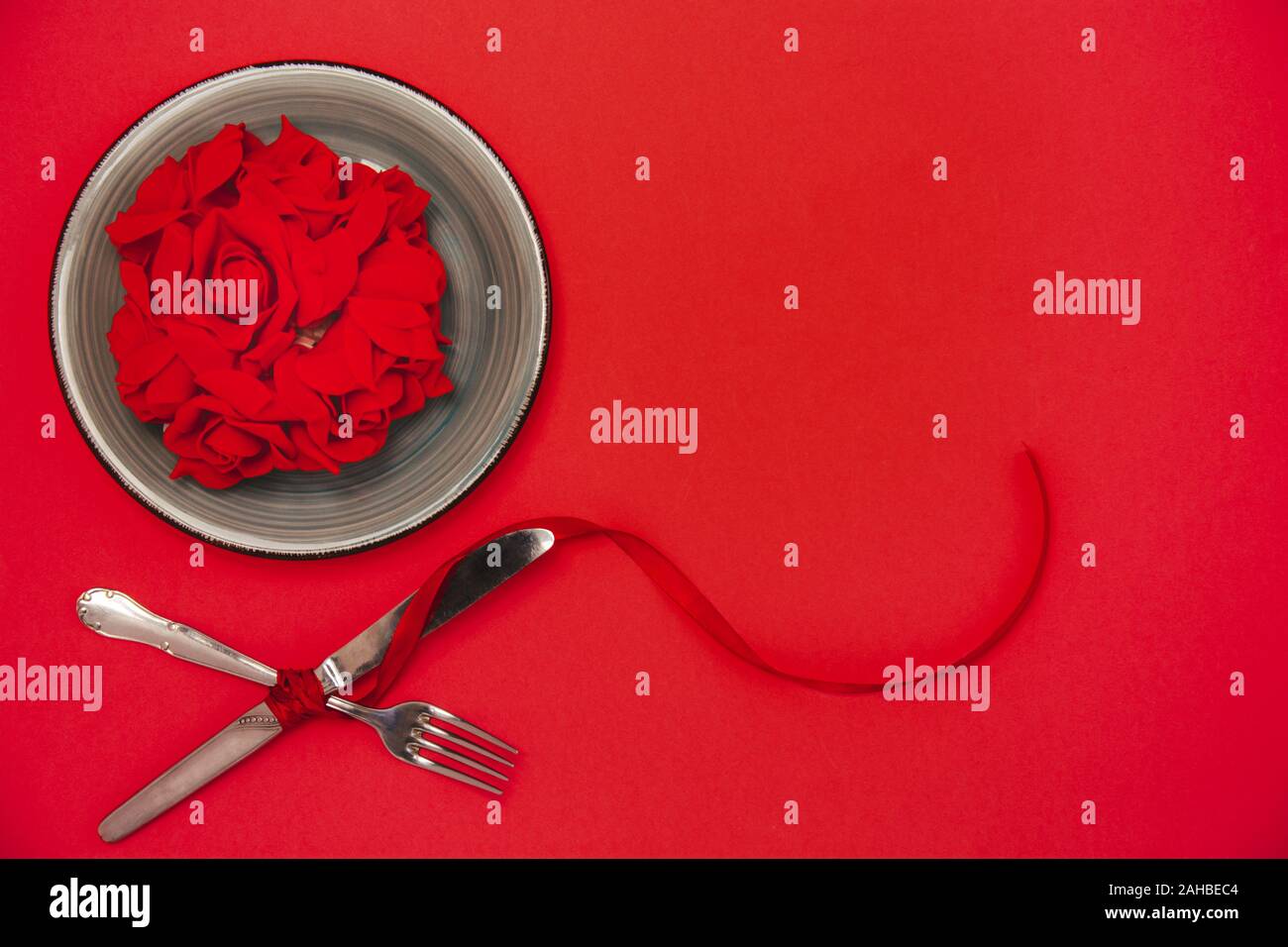 Red rose on white dish.Meal on Valentines Day. Top view. Valentine's ...