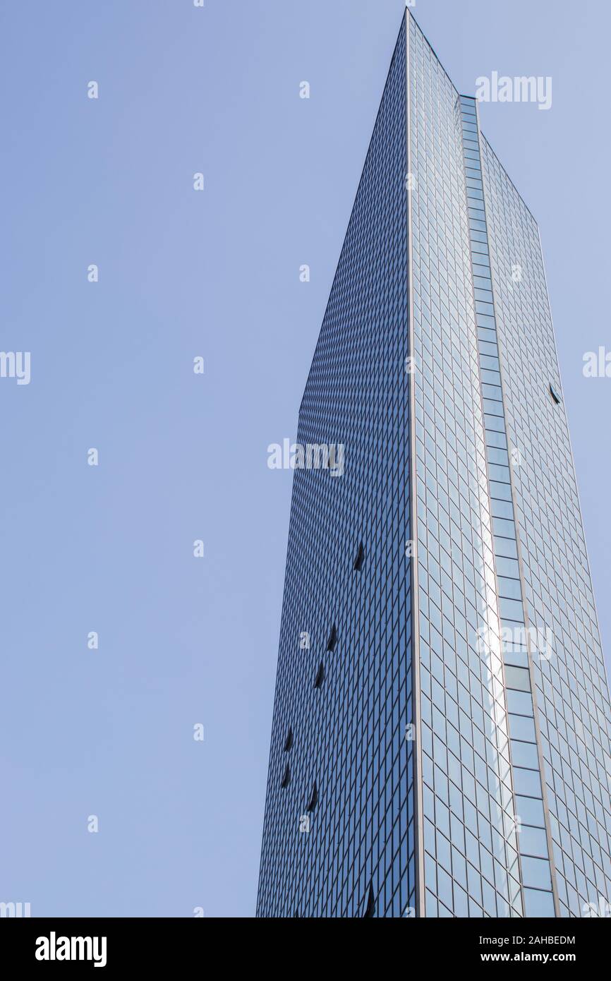 A tall glass skyscraper on a blue sky background in Naples, Italy Stock ...