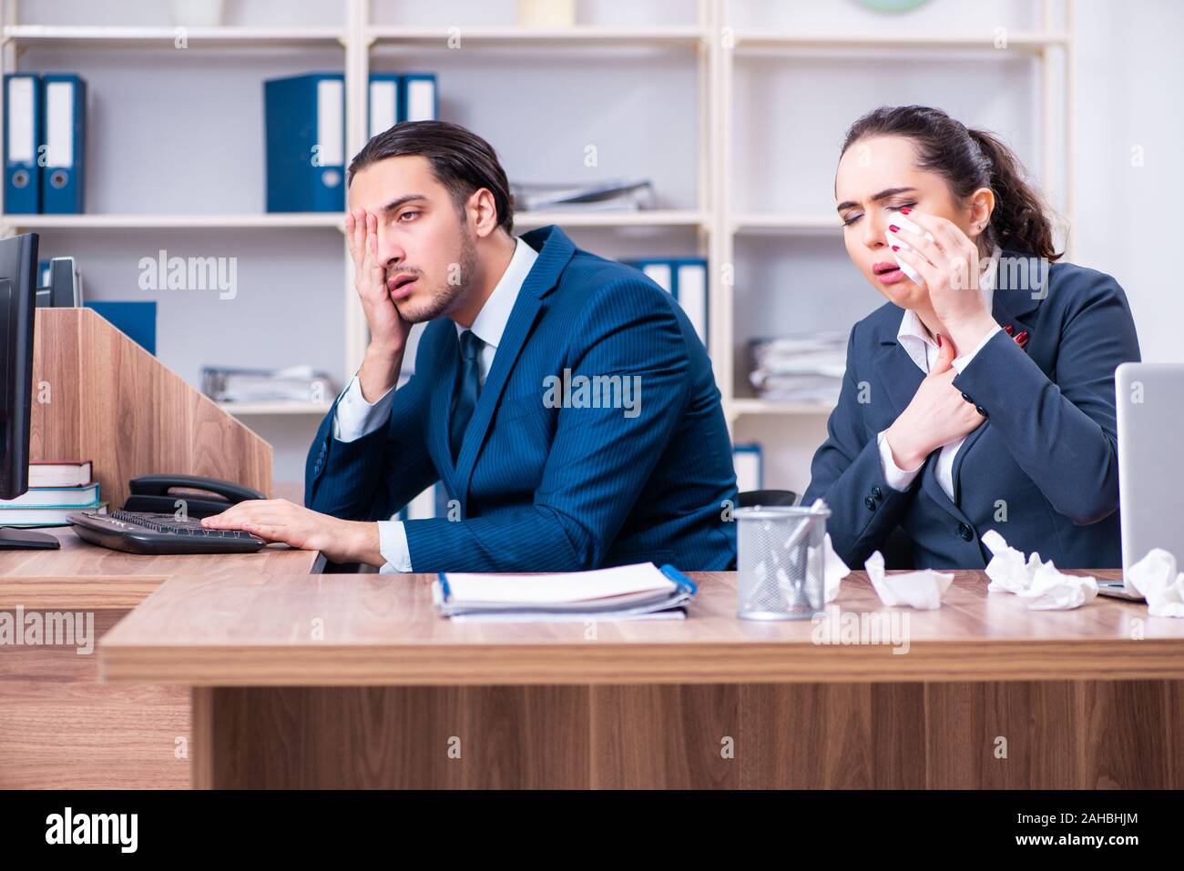 The two employees suffering at workplace Stock Photo - Alamy