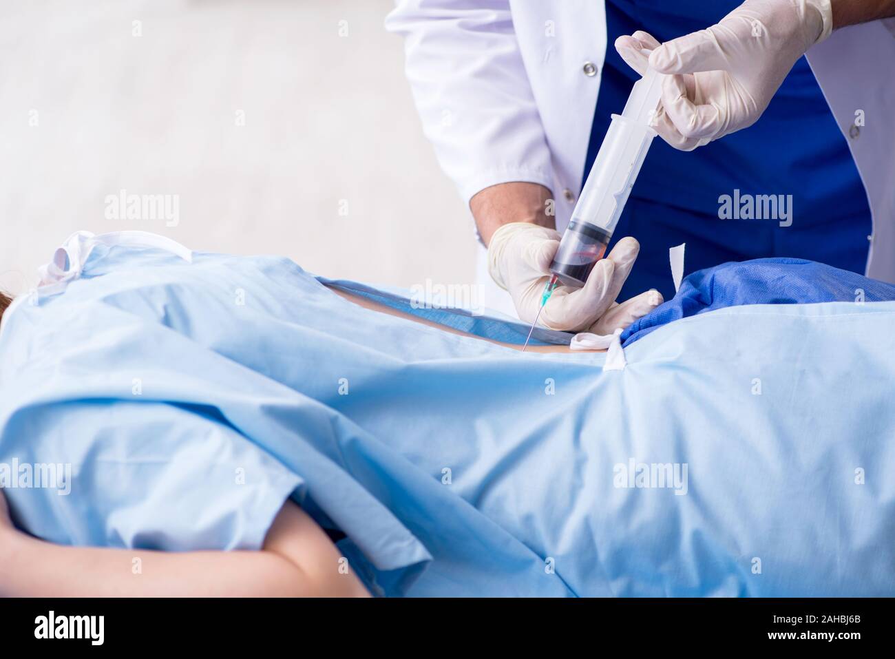 The female patient getting an injection in the clinic Stock Photo - Alamy