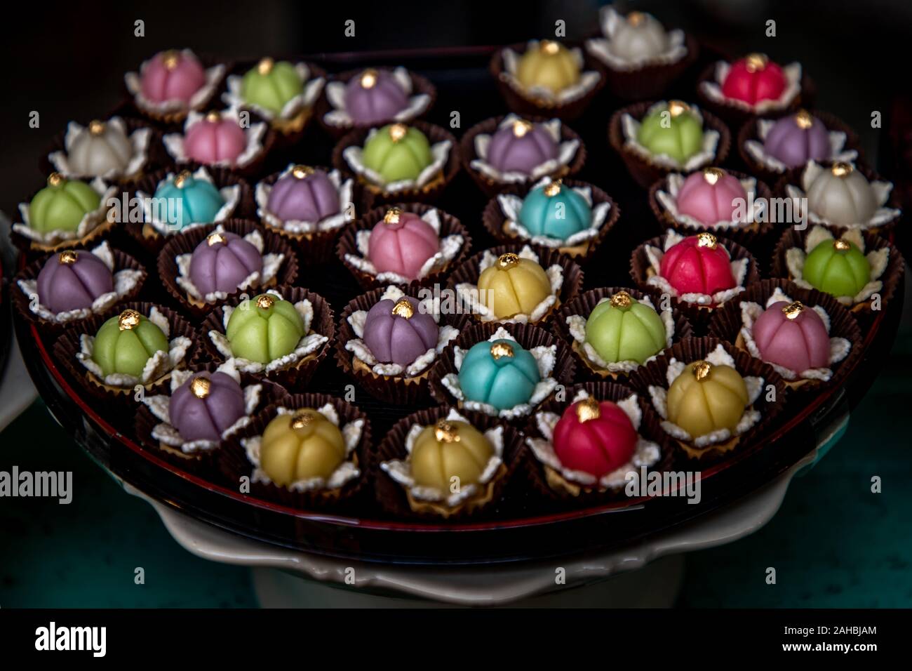 A variety of elegantly beautiful Thai Desserts (Khanom Wan Thai) colorful variations serving in ...