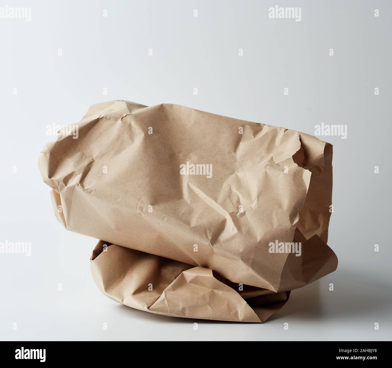 pile of twisted brown sheets of paper on a white background, craft ...