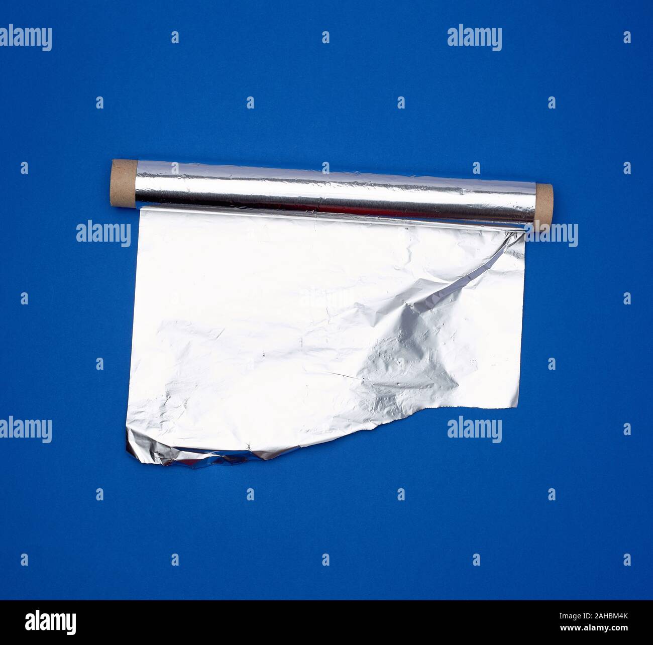 roll of gray foil for baking and packaging food on a dark blue ...
