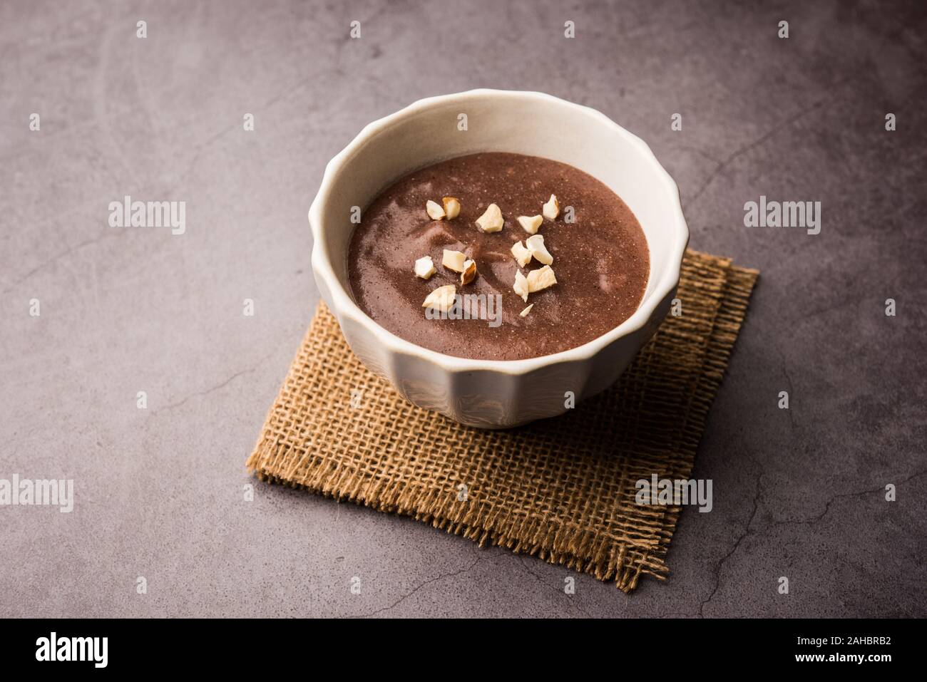 Sweet Ragi Malt / Healthy Ragi Porridge in a bowl garnished with ...