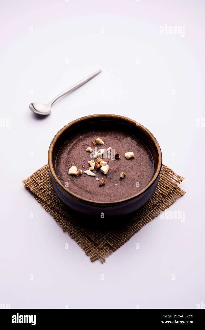 Sweet Ragi Malt / Healthy Ragi Porridge in a bowl garnished with ...