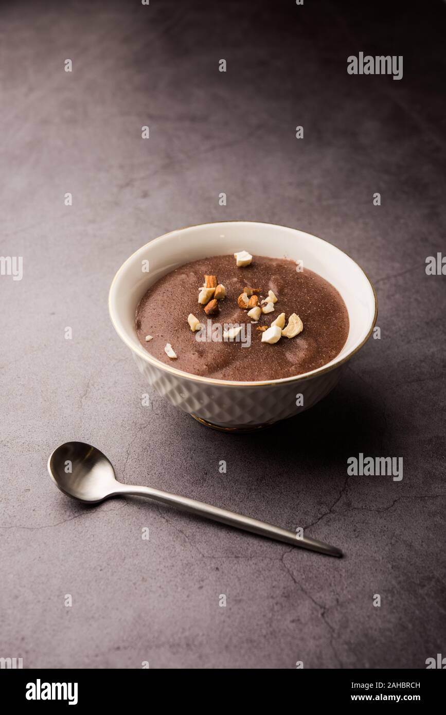 Sweet Ragi Malt / Healthy Ragi Porridge in a bowl garnished with ...