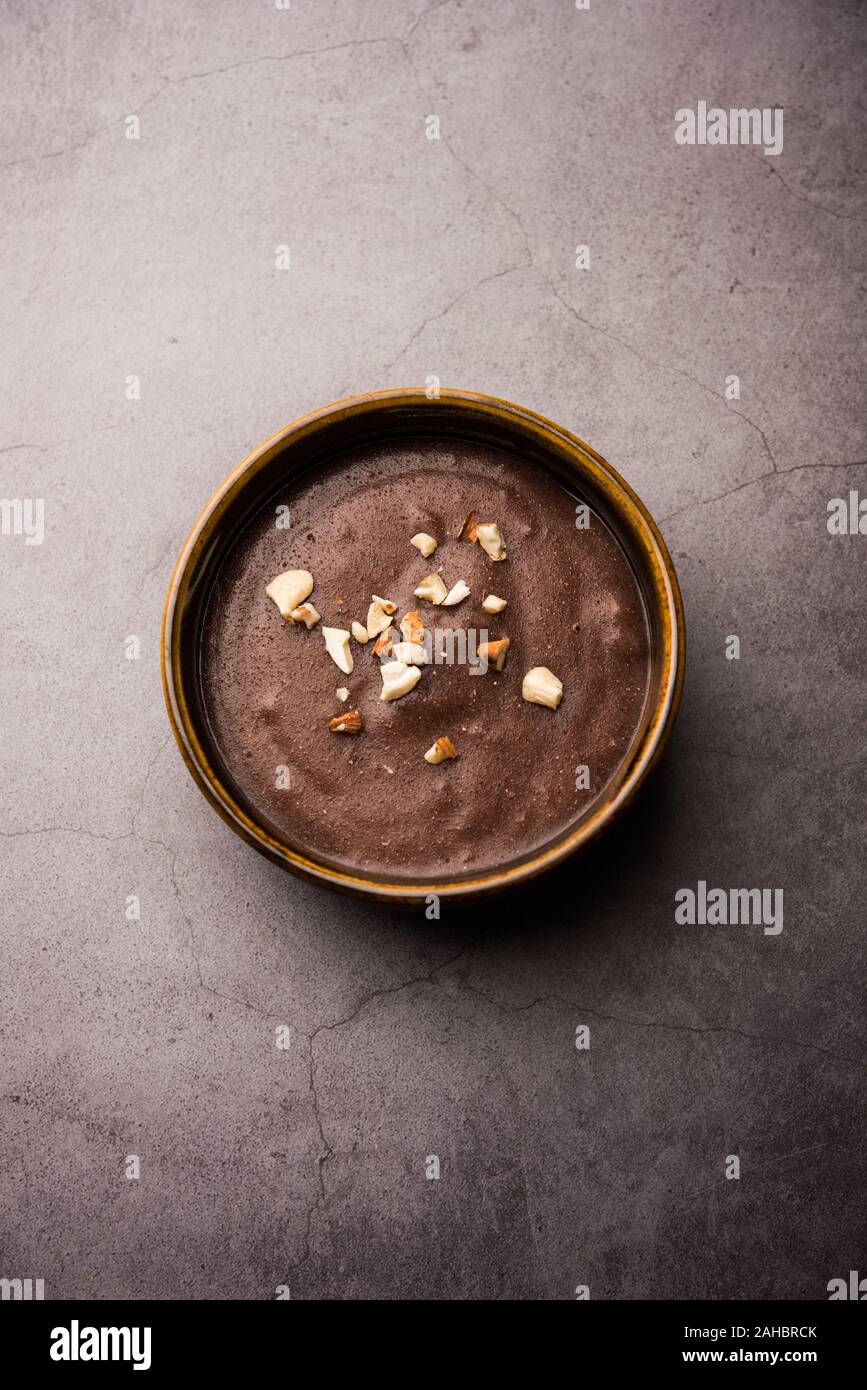 Sweet Ragi Malt / Healthy Ragi Porridge in a bowl garnished with ...