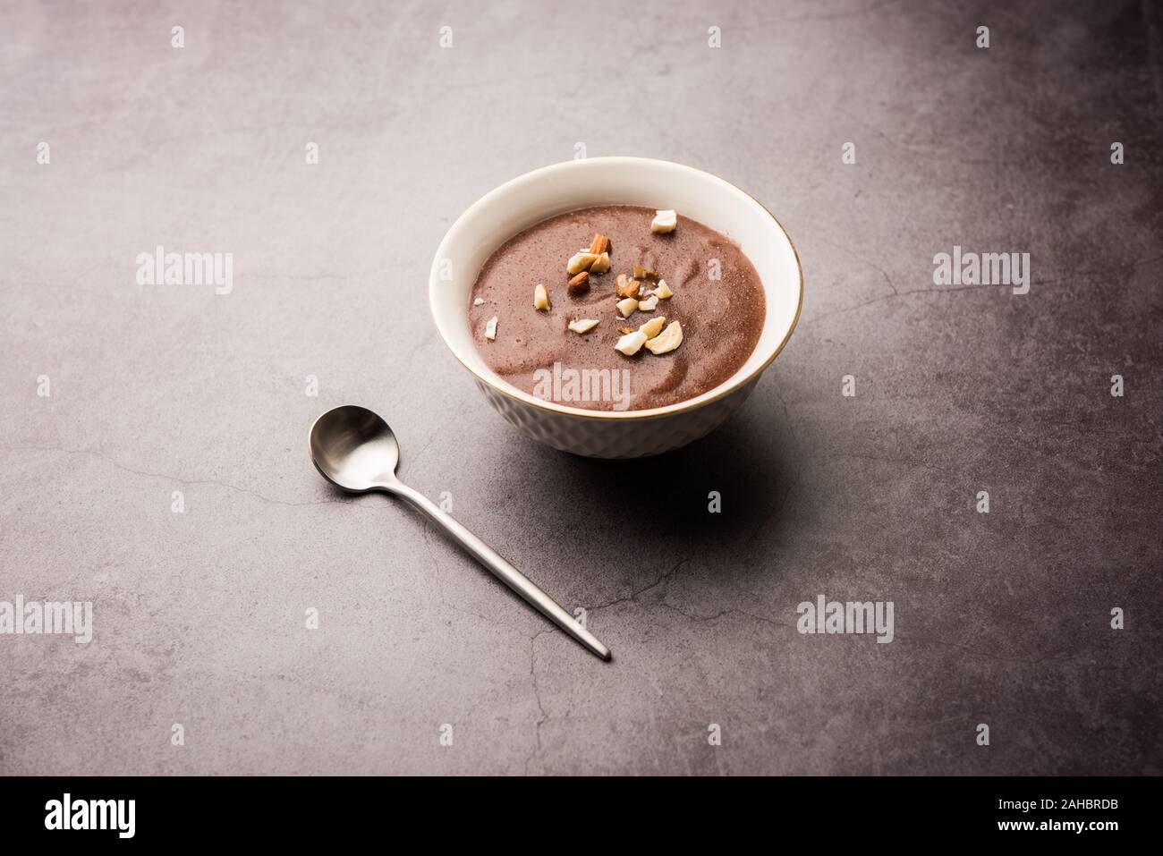Sweet Ragi Malt / Healthy Ragi Porridge in a bowl garnished with ...