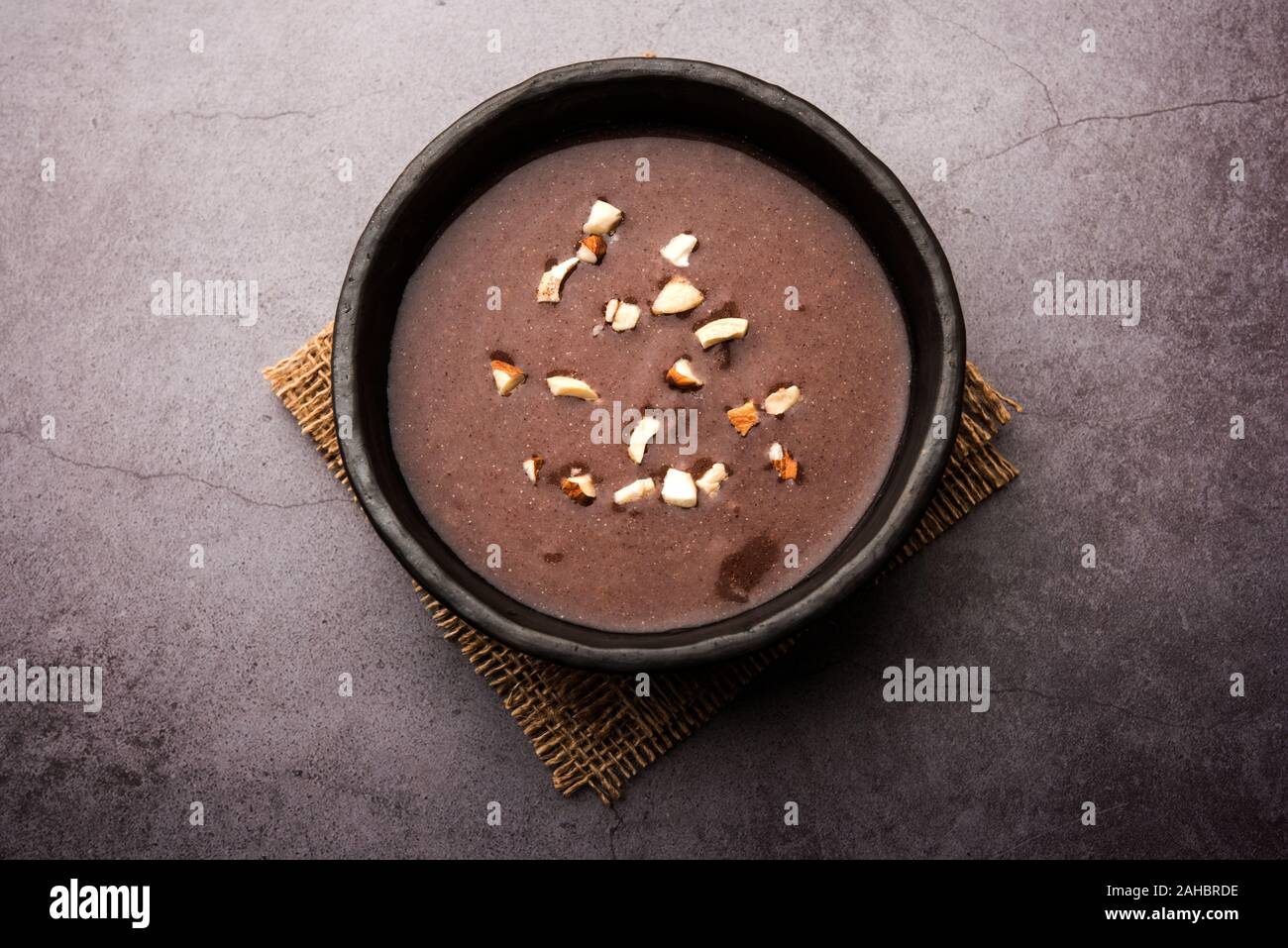 Sweet Ragi Malt / Healthy Ragi Porridge in a bowl garnished with ...