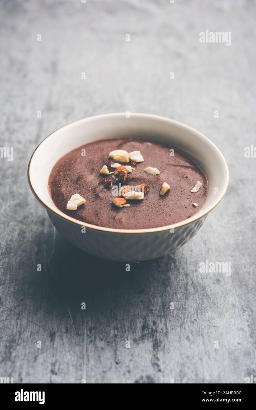 Sweet Ragi Malt / Healthy Ragi Porridge in a bowl garnished with ...