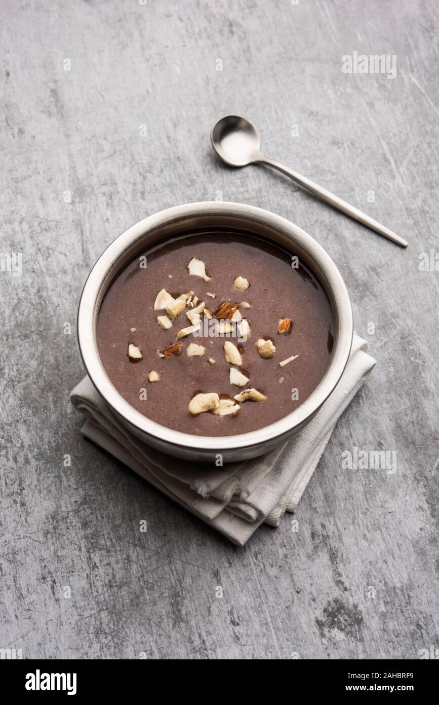 Sweet Ragi Malt / Healthy Ragi Porridge in a bowl garnished with ...