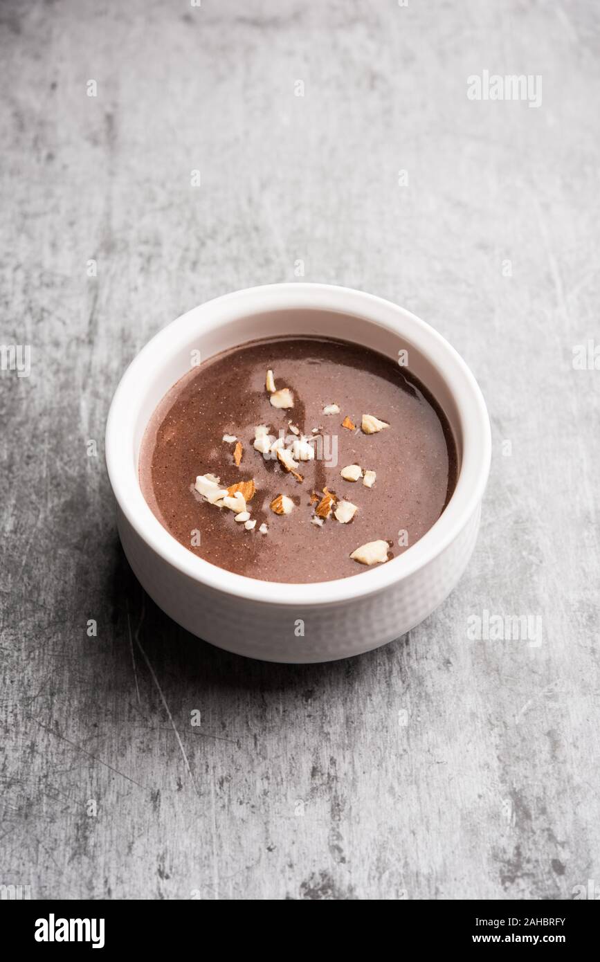 Sweet Ragi Malt / Healthy Ragi Porridge in a bowl garnished with ...